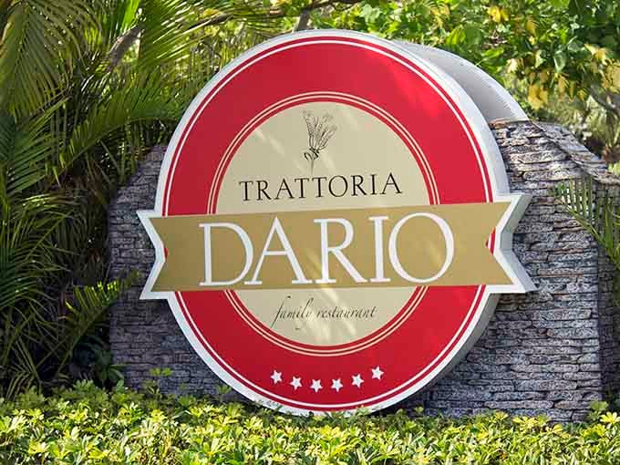 The Trattoria Dario sign welcomes you to a family restaurant where authentic Italian cuisine awaits inside.