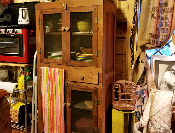This antique wooden cabinet displays vintage dishware behind glass doors&mdash;everyday objects from another era that might hold energetic imprints of their former owners.