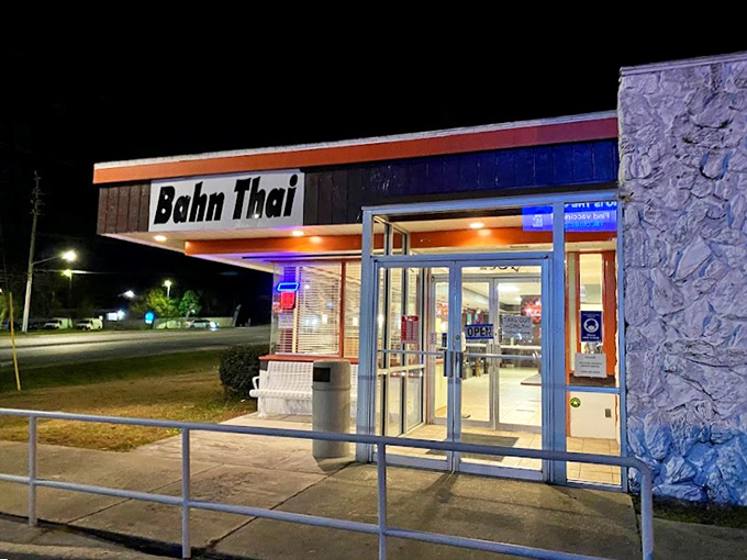 The illuminated storefront beckons hungry diners after dark, promising a warm welcome and flavors that transport you halfway around the world.