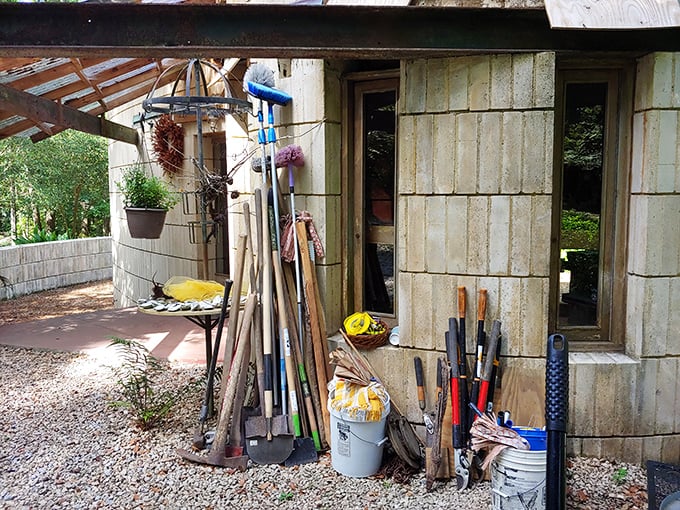 Garden tools stand ready for the never-ending battle between preservation and nature's determination to reclaim this architectural treasure.