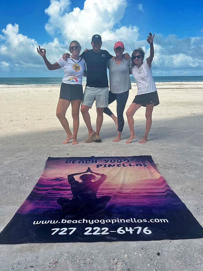 Four friends celebrate their beach yoga session with joyful poses, their camaraderie as bright as the Florida sunshine reflecting off the Gulf waters behind them.