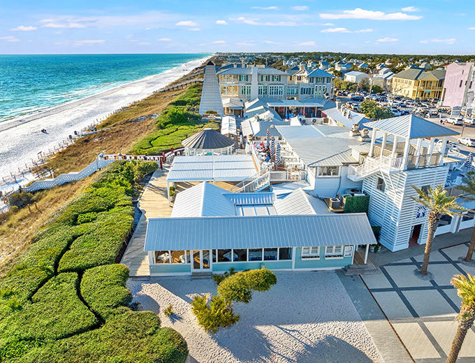 High-angle shot: A bird's-eye view of paradise &ndash; white rooftops, emerald waters, and sandy shores create the perfect setting for unforgettable meals.