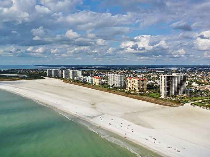 A bird's-eye view reveals the stunning contrast between emerald waters and sugar-white sands.