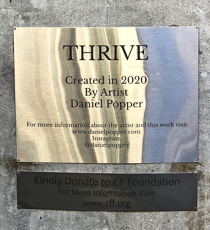 The plaque reveals this is "Thrive" by Daniel Popper, created in 2020 &ndash; a relatively new addition that already feels like an essential part of Miami's landscape.