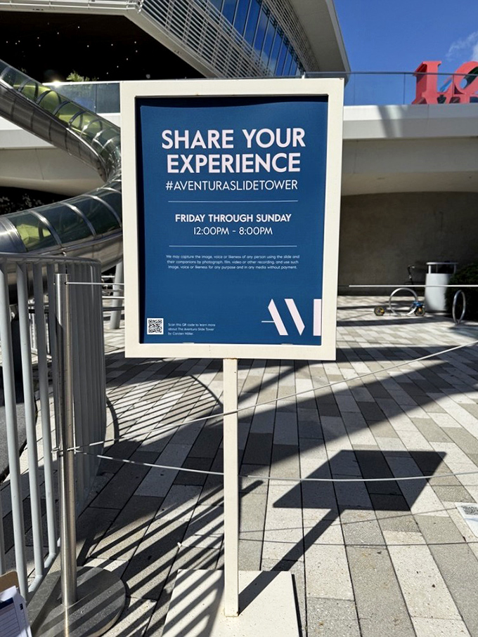 The sign invites visitors to share their experiences, creating a community of joy-seekers connected by those unforgettable seconds of descent.
