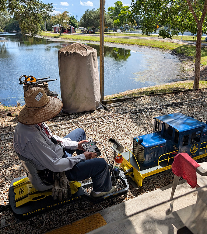 A dedicated operator in traditional railroad attire pilots his miniature locomotive. The passion these volunteers bring to their hobby is what makes this attraction truly special.