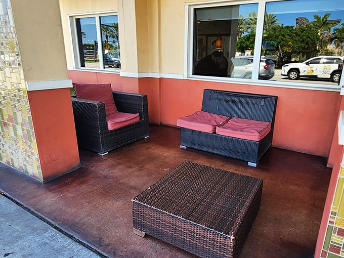 The outdoor seating area offers a moment of Florida tranquility. These cushioned chairs have witnessed countless post-meal sighs of satisfaction and "I shouldn't have eaten that much" confessions.