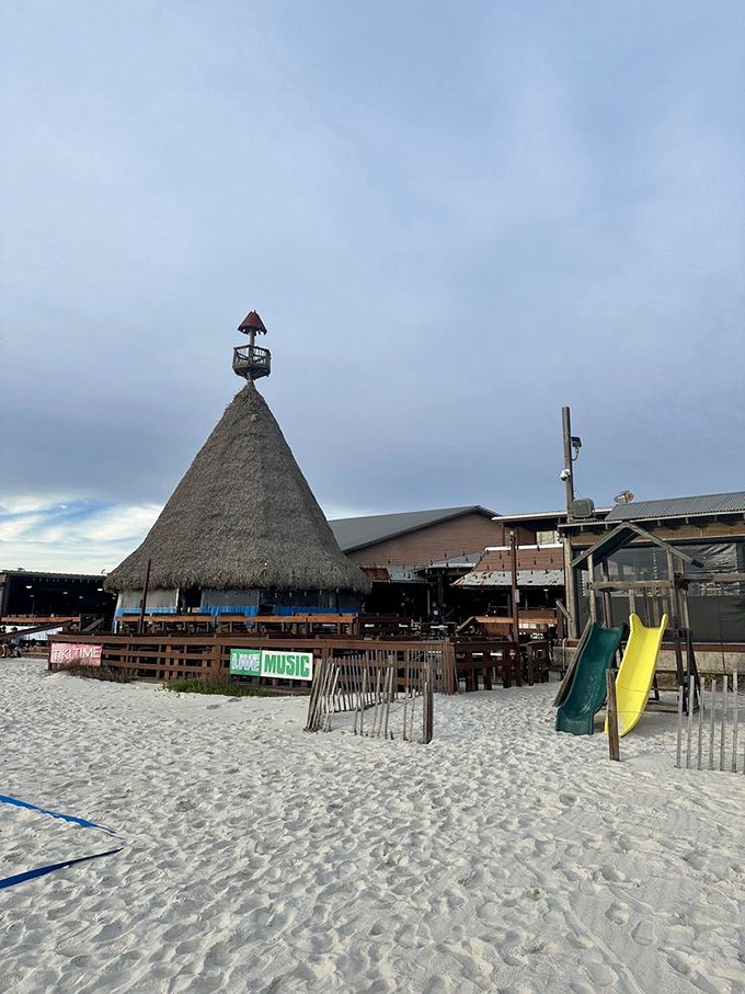 The thatched tiki hut stands sentinel on the white sands, a landmark visible up and down the beach and a beacon for hungry swimmers.