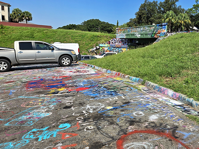 Parking areas show evidence of artistic overflow, where even the ground becomes part of this sprawling creative experiment.