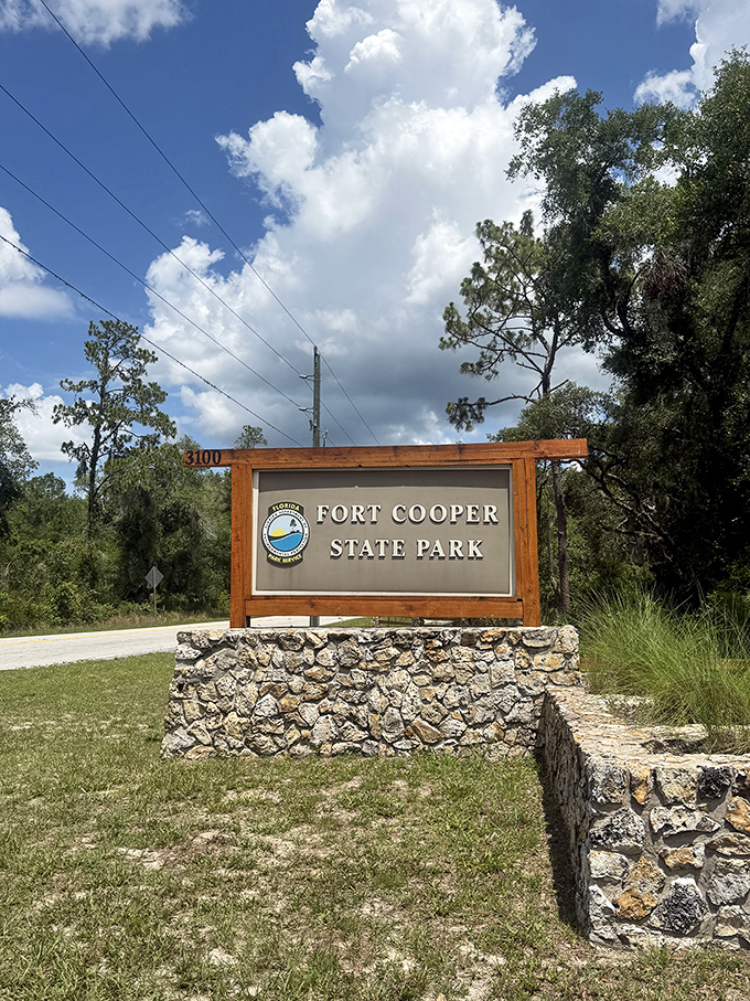 Fort Cooper State Park welcomes visitors with its rustic wooden sign, standing as a gateway to Florida's rich historical tapestry.