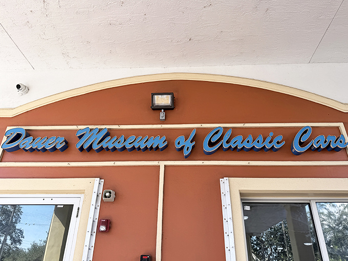 The blue neon promise of automotive wonders within &ndash; like a lighthouse guiding car lovers to their happy place.
