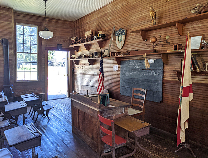 The teacher's desk commands respect at the front of the classroom, a reminder of when educators were among the most esteemed members of society.