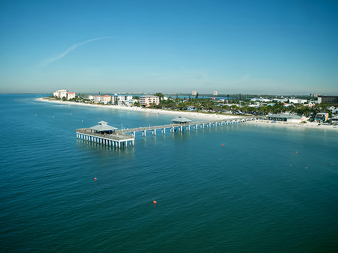 Fort Myers Beach stretches into the horizon with its iconic pier jutting into the turquoise Gulf waters, a postcard-perfect scene under the Florida sun.