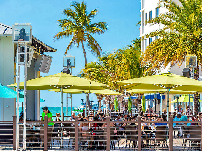 Sunshine paradise at Shephard's Tiki Beach Bar & Grill, where lime-green umbrellas dot the deck and the Gulf of Mexico sparkles just steps away.