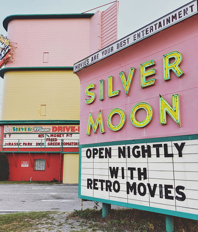 The Silver Moon's cotton candy-pink facade and glowing neon sign promise a night of retro movie magic under Florida stars.