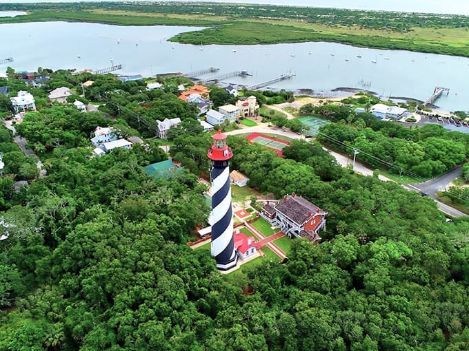 That candy-striped lighthouse looks cheerful until you learn about the ghostly children who supposedly haunt its spiral staircase.
