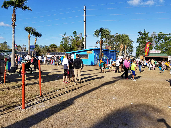 Blue skies and palm trees frame the perfect setting where food trucks and eager crowds gather for barbecue bliss.