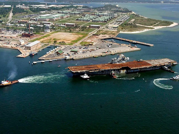 From above, the sunken carrier creates an impressive silhouette against the sandy bottom &ndash; an underwater skyscraper with fish as its new tenants.