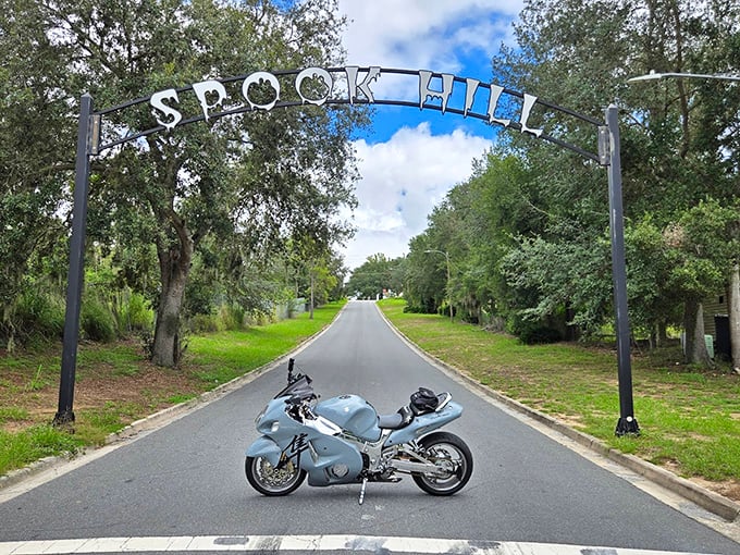 A sleek motorcycle waits at the starting line of Spook Hill's optical illusion, ready to experience the supernatural pull that defies explanation.