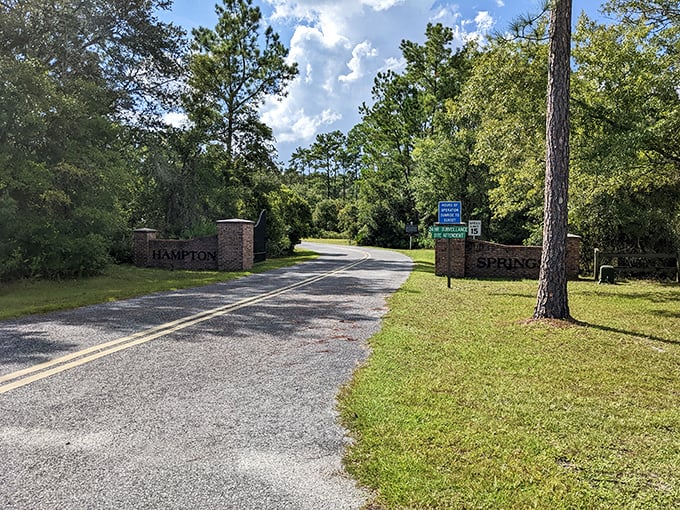 The entrance to Hampton Springs stands like a portal to the past, brick pillars guarding secrets of the Roaring Twenties.