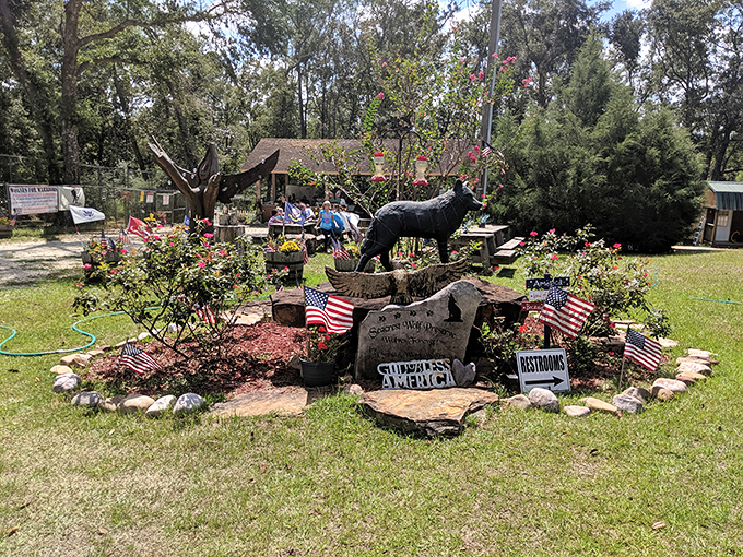 A memorial garden stands as testament to the preserve's mission, with statues and American flags honoring the wild spirit of conservation.