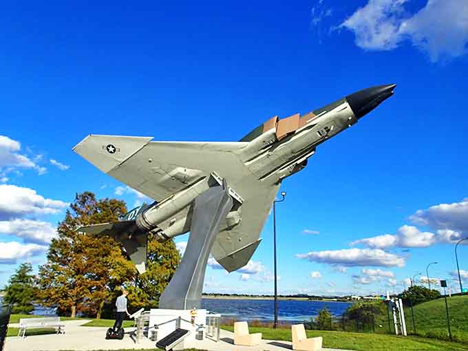 The F-4 Phantom II stands frozen in eternal ascent, its olive-green fuselage gleaming under Florida's generous sunshine.