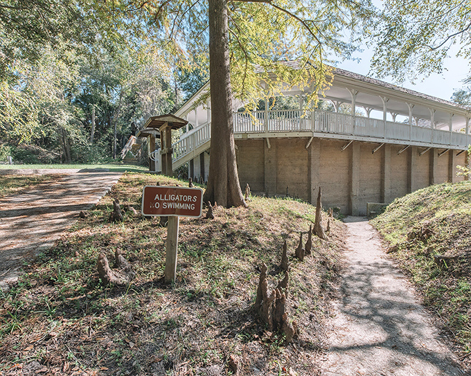 A warning sign about alligators adds a distinctly Florida twist to this abandoned bathhouse &ndash; nature always reclaims what humans leave behind.