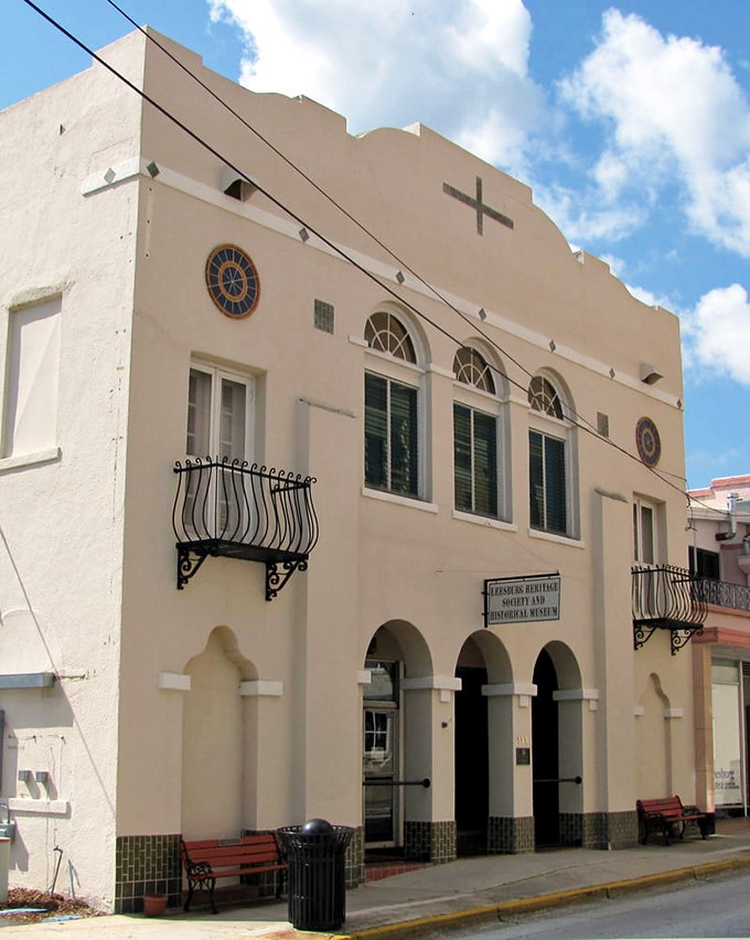 Sunlight plays across the cream-colored exterior, where decorative iron balconies and arched entryways welcome curious minds to explore Leesburg's storied past.