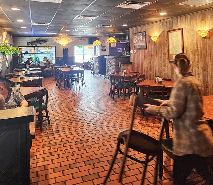 Warm wood paneling and brick floors create that classic steakhouse ambiance where conversations flow as smoothly as the cocktails.