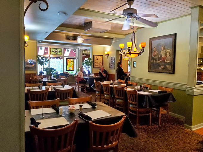 Warm lighting and comfortable wooden chairs create an atmosphere where lingering over coffee and conversation feels not just allowed, but encouraged.