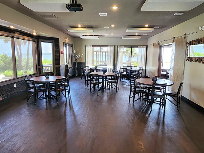 Sunlight streams through generous windows, creating a dining room where every table feels special and the outside view becomes part of the decor.