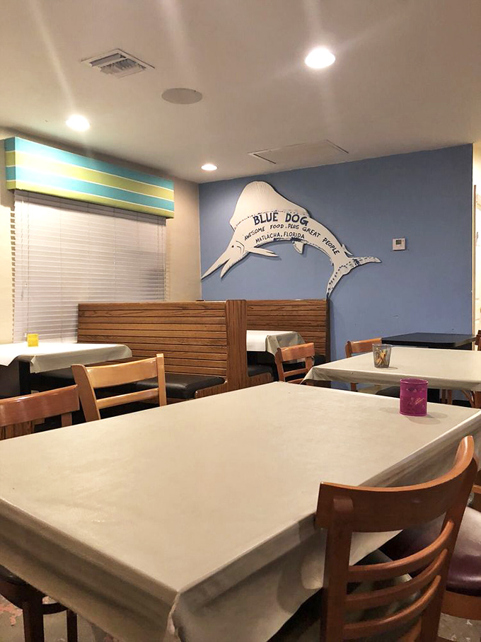 Simple wooden booths and blue walls create that perfect "come as you are" atmosphere where memorable meals unfold.