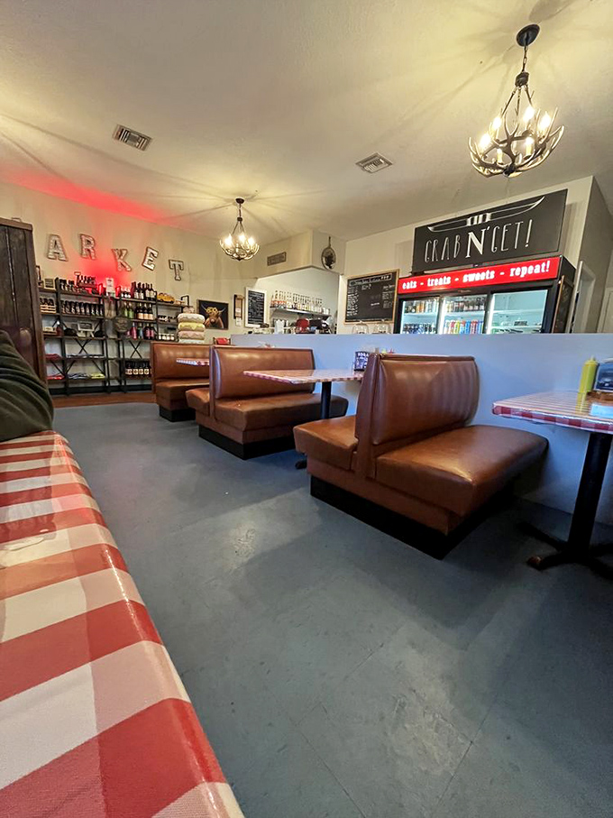 Step inside to a world where leather booths meet checkered tablecloths, and antler chandeliers cast a warm glow over conversations worth savoring.