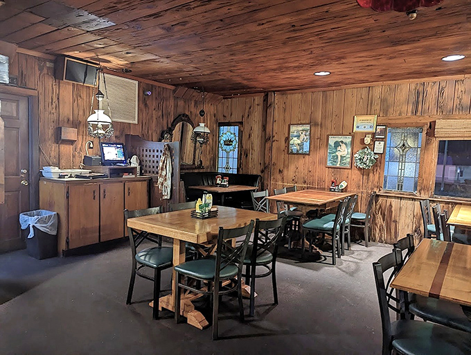 Warm wood paneling embraces diners in nostalgic comfort, while stained glass windows filter light across tables where both the living and perhaps... others dine.