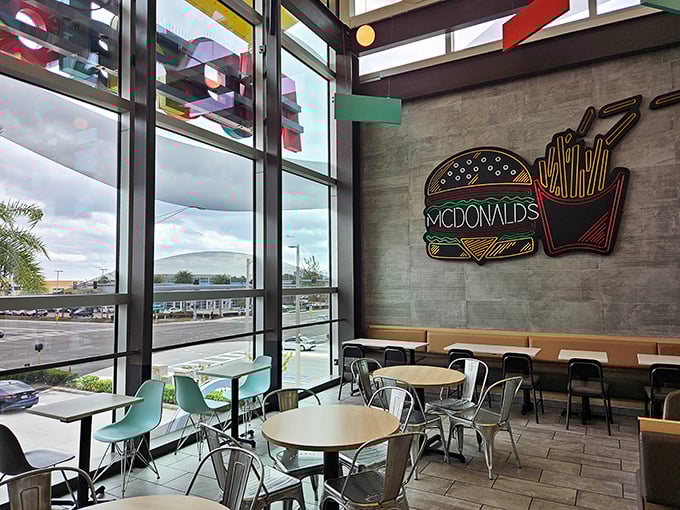Industrial-chic meets fast food fantasy with neon burger art that screams "this isn't your neighborhood drive-thru."
