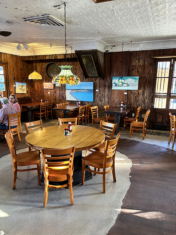 Warm wooden walls and Tiffany-style lamps create the cozy ambiance of a friend's beach house you never want to leave.