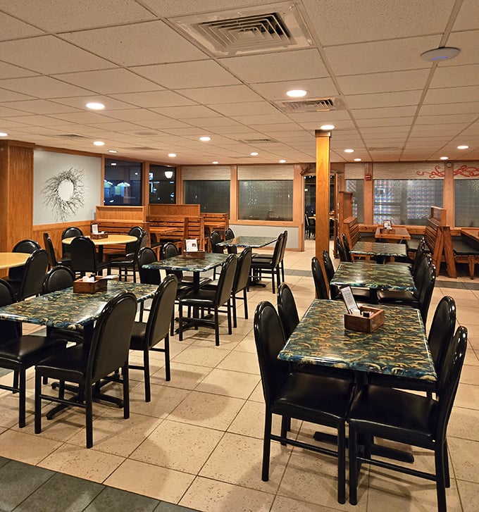 Simple elegance defines the dining room, where countless seafood stories have unfolded across tables adorned with distinctive ocean-blue patterns.