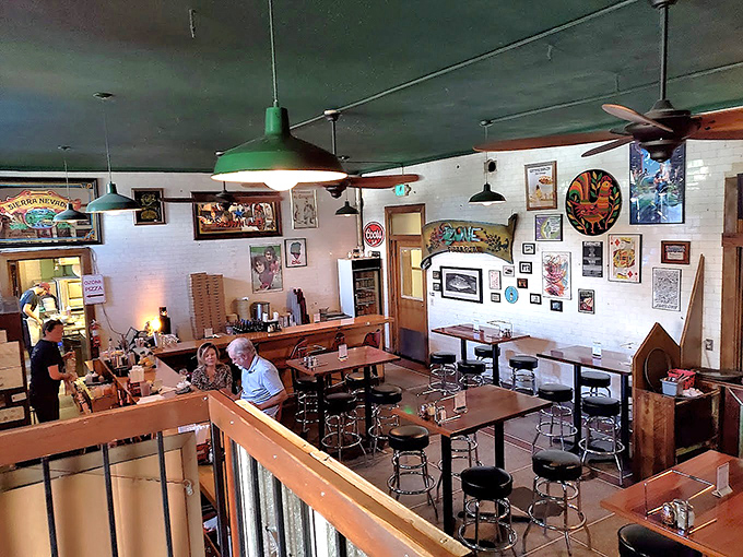 Where medieval meets modern comfort &ndash; wooden tables bathed in green pendant light create the perfect stage for pizza performances that never disappoint.