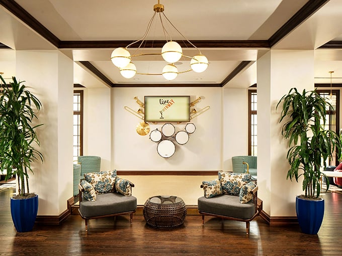 The lobby's stylish seating area features musical instruments mounted on the wall, nodding to the hotel's jazz-infused heritage.