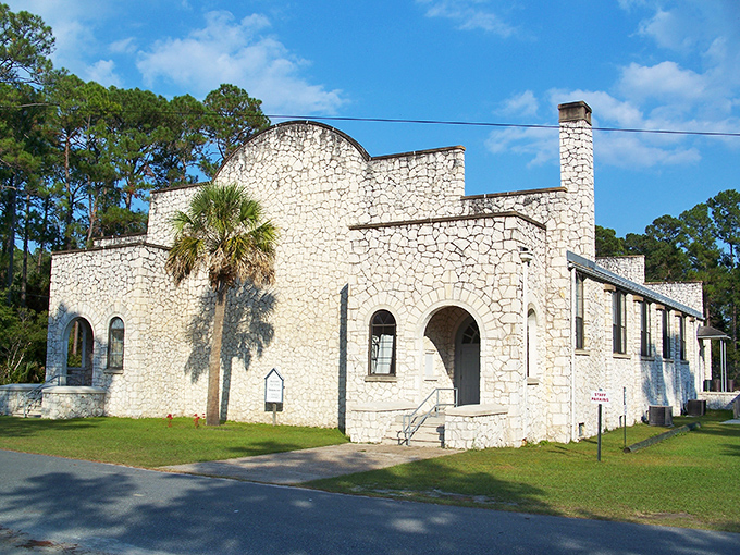 The Old Sopchoppy Gymnasium stands as a limestone testament to 1930s craftsmanship, its sturdy walls having witnessed generations of community gatherings.
