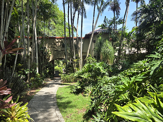 Winding stone pathways guide explorers through The Kampong's lush grounds, where every turn promises a new botanical surprise.
