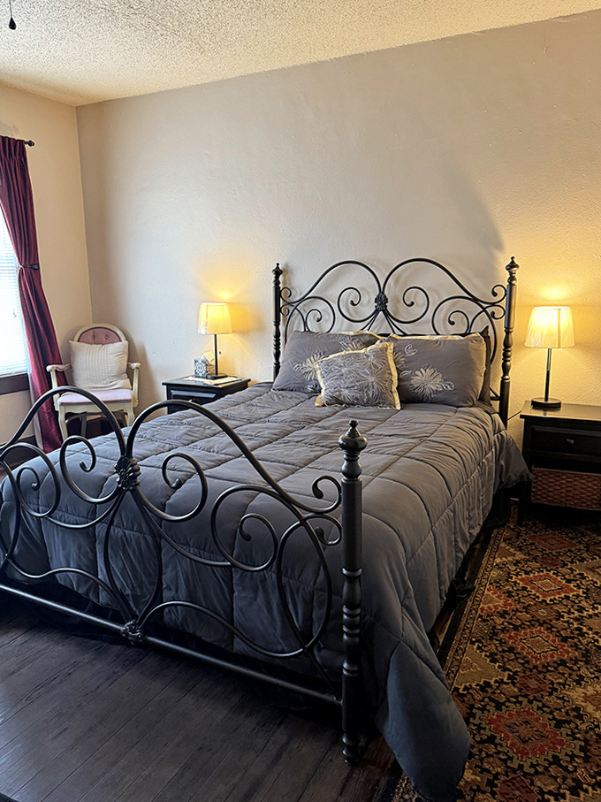 An elegant wrought-iron bed frame that's witnessed decades of both ordinary sleep and extraordinary visitations. The pillows look comfortable, but who knows what dreams they might inspire?