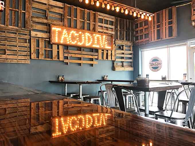 Reclaimed wood pallets and string lights create an industrial-chic vibe that's somehow both Instagram-worthy and genuinely comfortable for actual dining.
