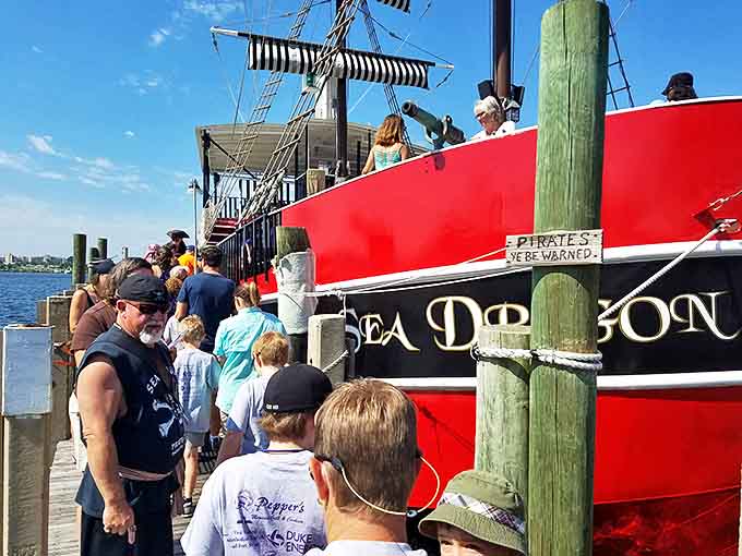 "Pirates ye be warned!" Excited tourists line up to board the Sea Dragon, trading ordinary vacation moments for swashbuckling memories.