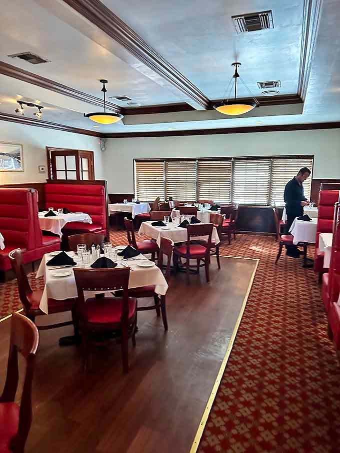 Red booths and white tablecloths create the perfect setting where comfort meets elegance for your Italian feast.
