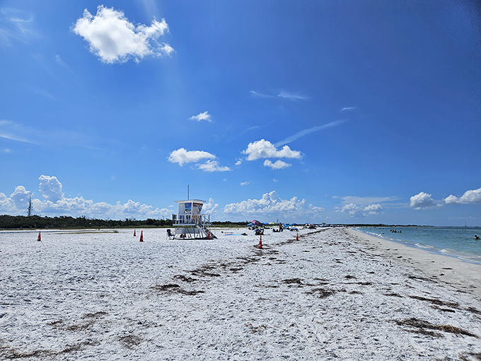 Under skies so blue they seem painted, beachgoers stake their claim on powdery white sands that squeak underfoot like nature's welcome mat.