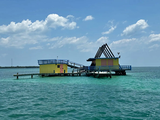 Cheerful yellows and pinks brighten this stilted structure, a tropical mirage floating on Biscayne Bay's crystal waters.