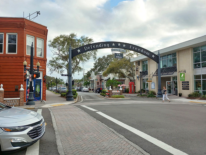 Downtown Dunedin's "Defending Freedom" arch frames a Main Street that looks like it was designed by someone who actually likes people.