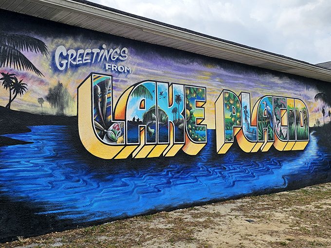 "Greetings from Lake Placid" announces this postcard-perfect mural, inviting visitors with tropical flair and vibrant blue waters.