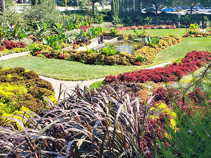 A kaleidoscope of colors greets visitors as meticulously designed garden beds create living artwork that changes with each season.
